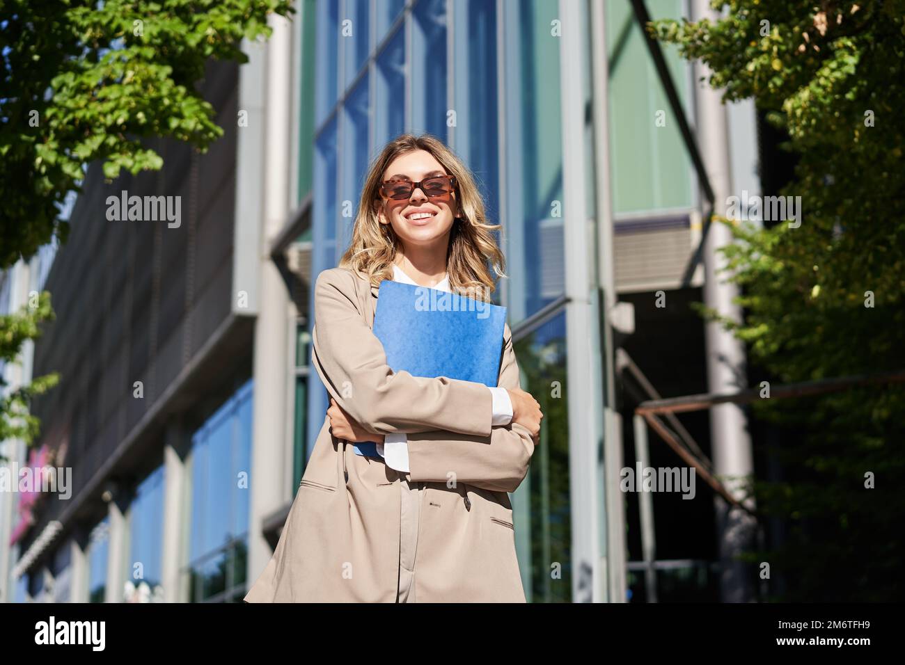 Portrait of confident office lady, business woman in sunglasses posing ...