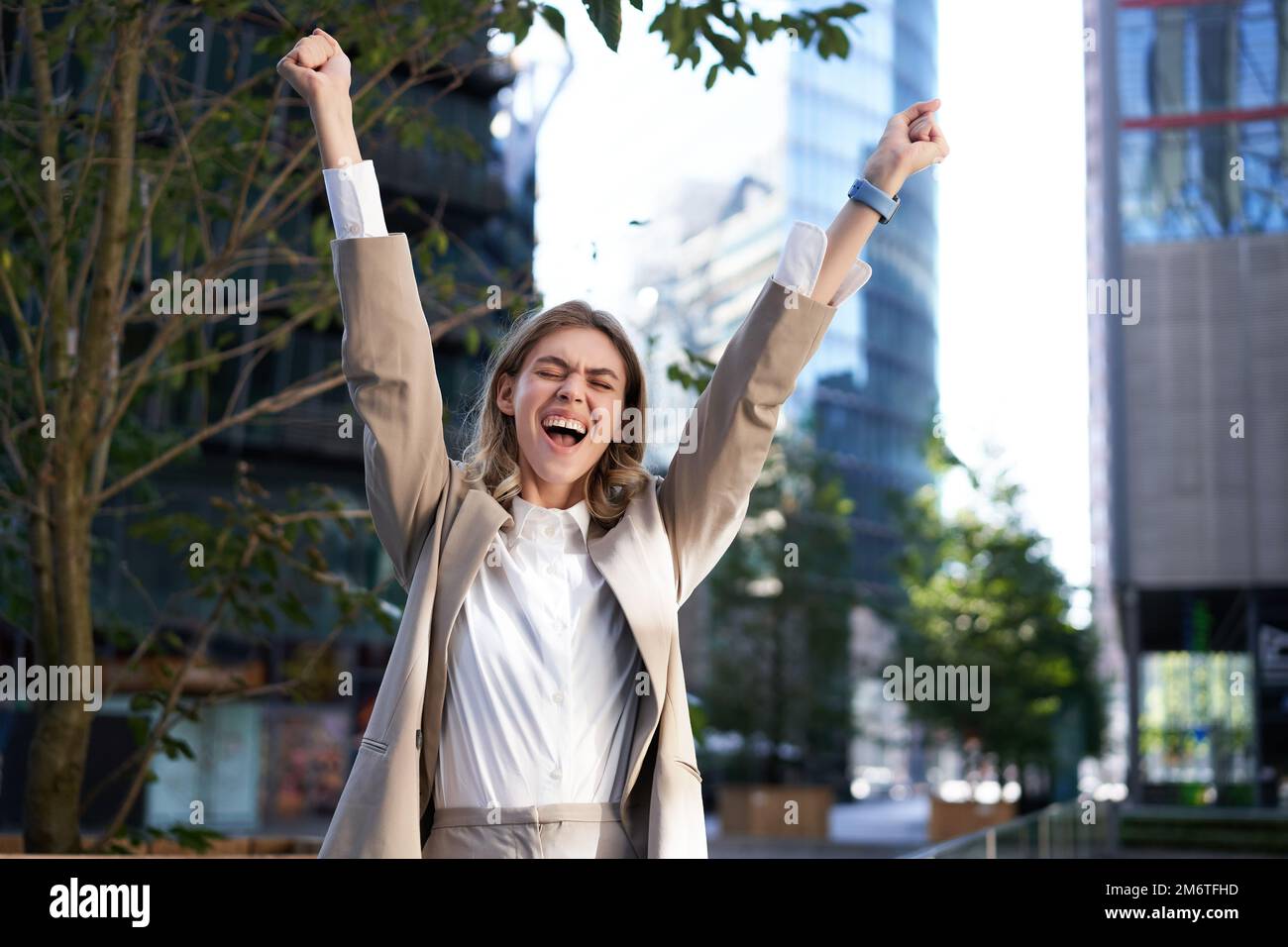 Happy businesswoman scream of joy, raise hands up in celebration ...