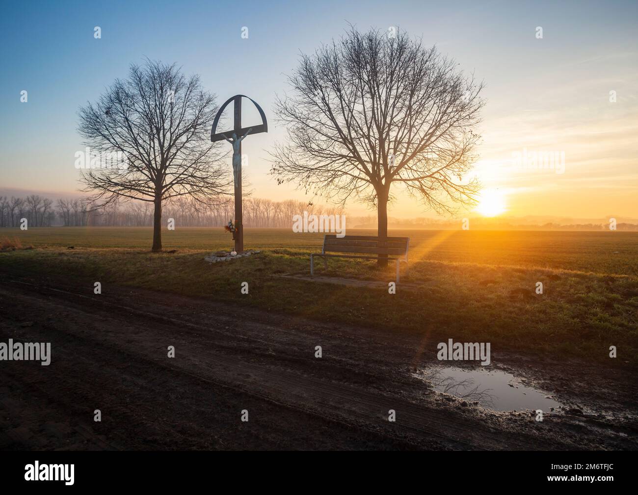 Crucifix in backlit field Stock Photo - Alamy