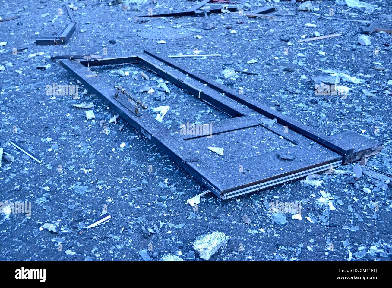 damaged door and glass pieces near destroyed residential building after ...