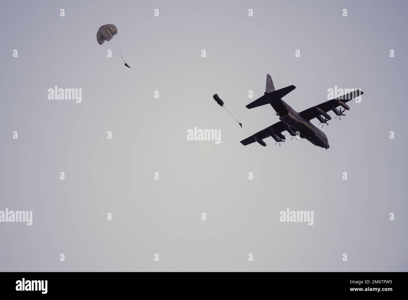 U.S. Army Special Forces members static-line jump out of an MC-130J ...