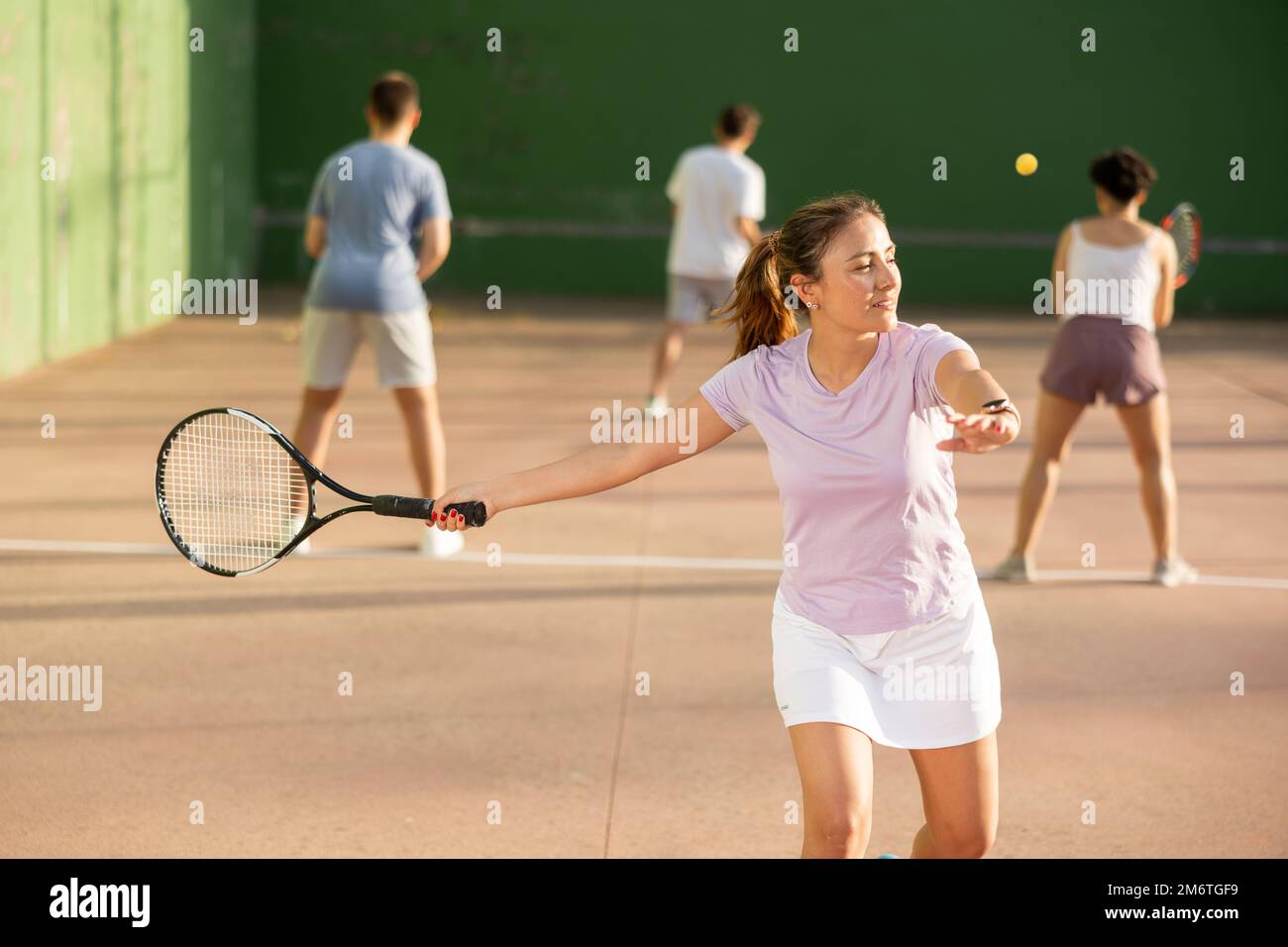 Woman pelota player hitting ball with racket Stock Photo - Alamy