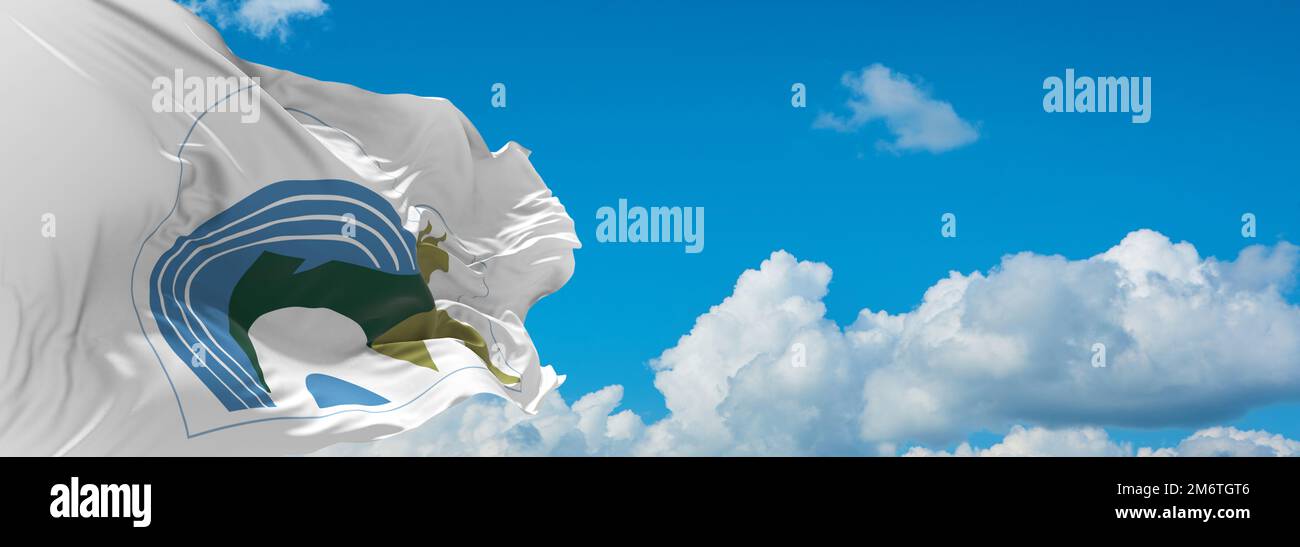 official flag of Inuvik Canada at cloudy sky background on sunset ...