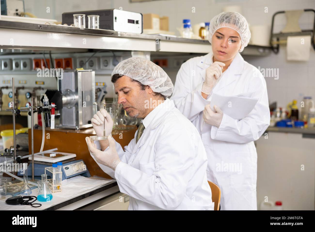 Man and woman scientists chemists conduct experiments in the laboratory ...