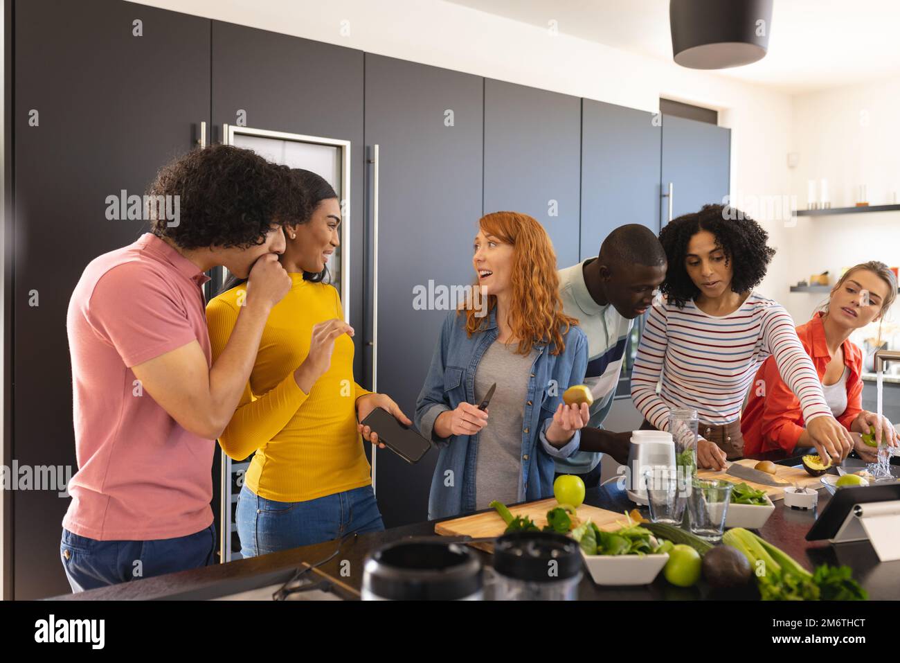Happy diverse friends cooking together and smiling in kitchen Stock ...