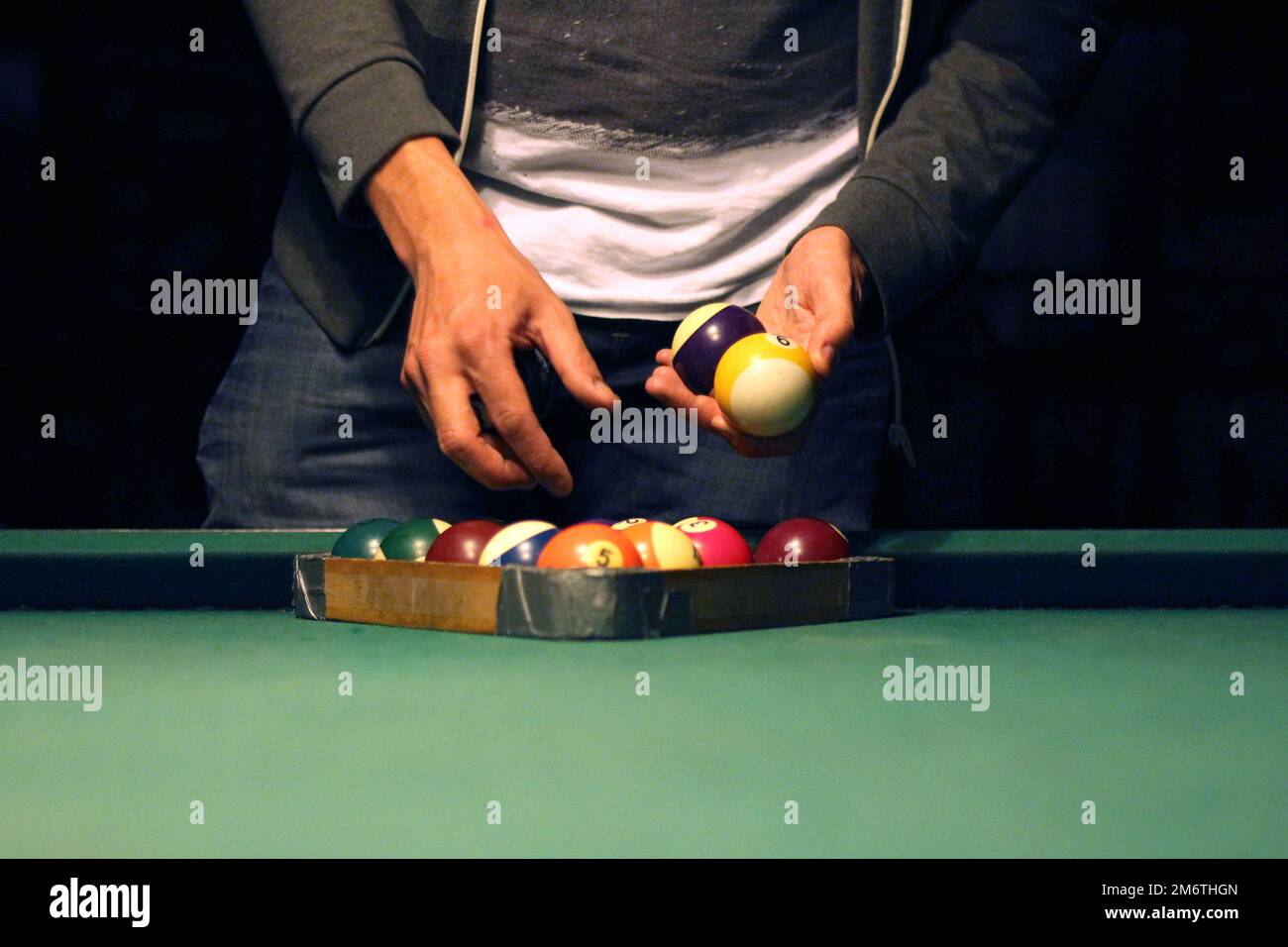 Male hands holding billiard balls with alight on, dark background Stock ...