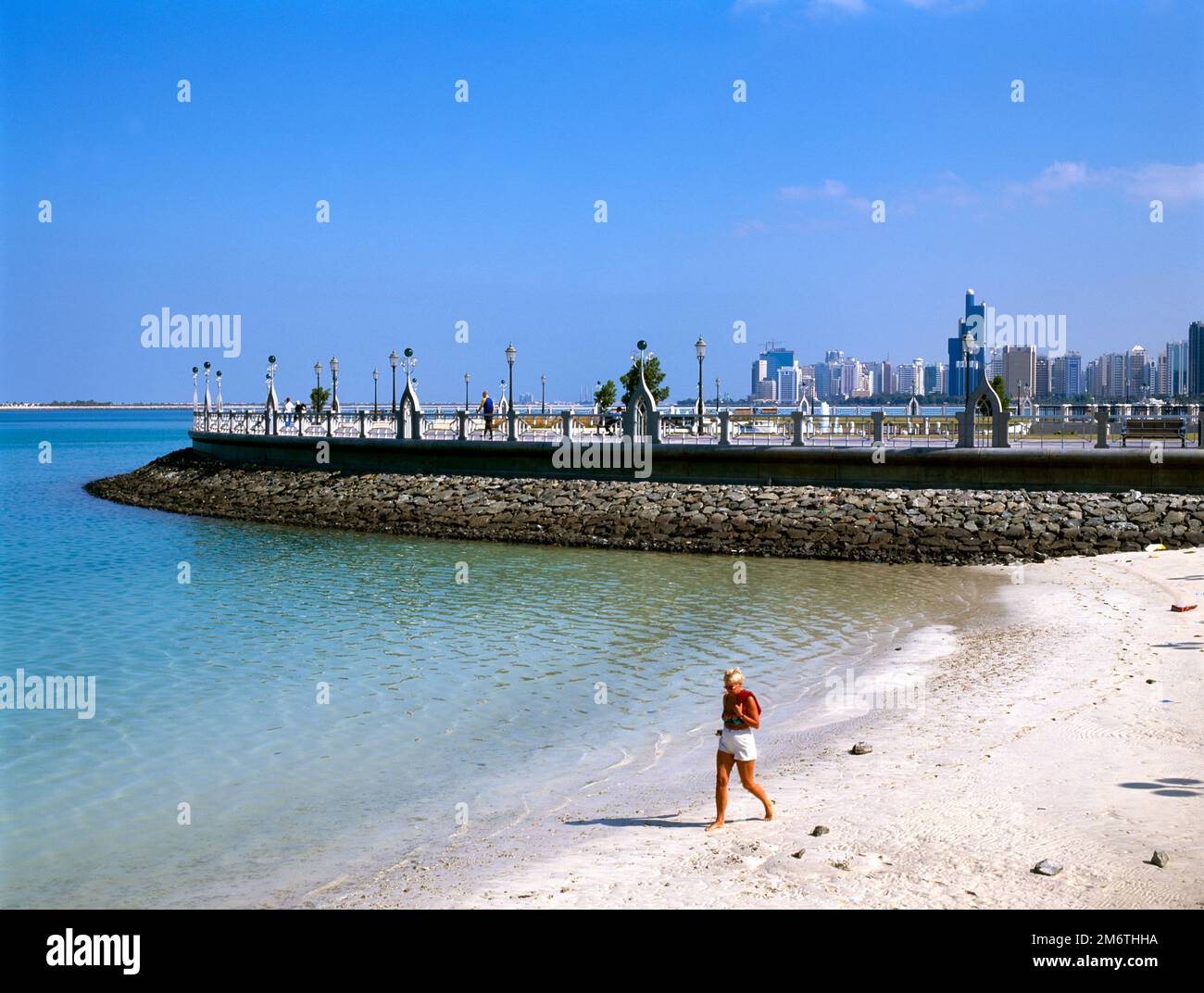 Abu Dhabi UAE Woman Walking On Beach Corniche & Skyline Stock Photo - Alamy