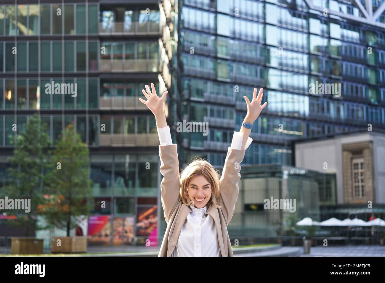 Corporate woman celebrating her victory outside on street. Happy ...