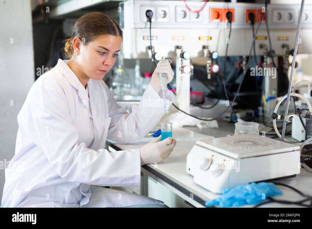 Shot of an young woman using equipment to work in a laboratory Stock ...
