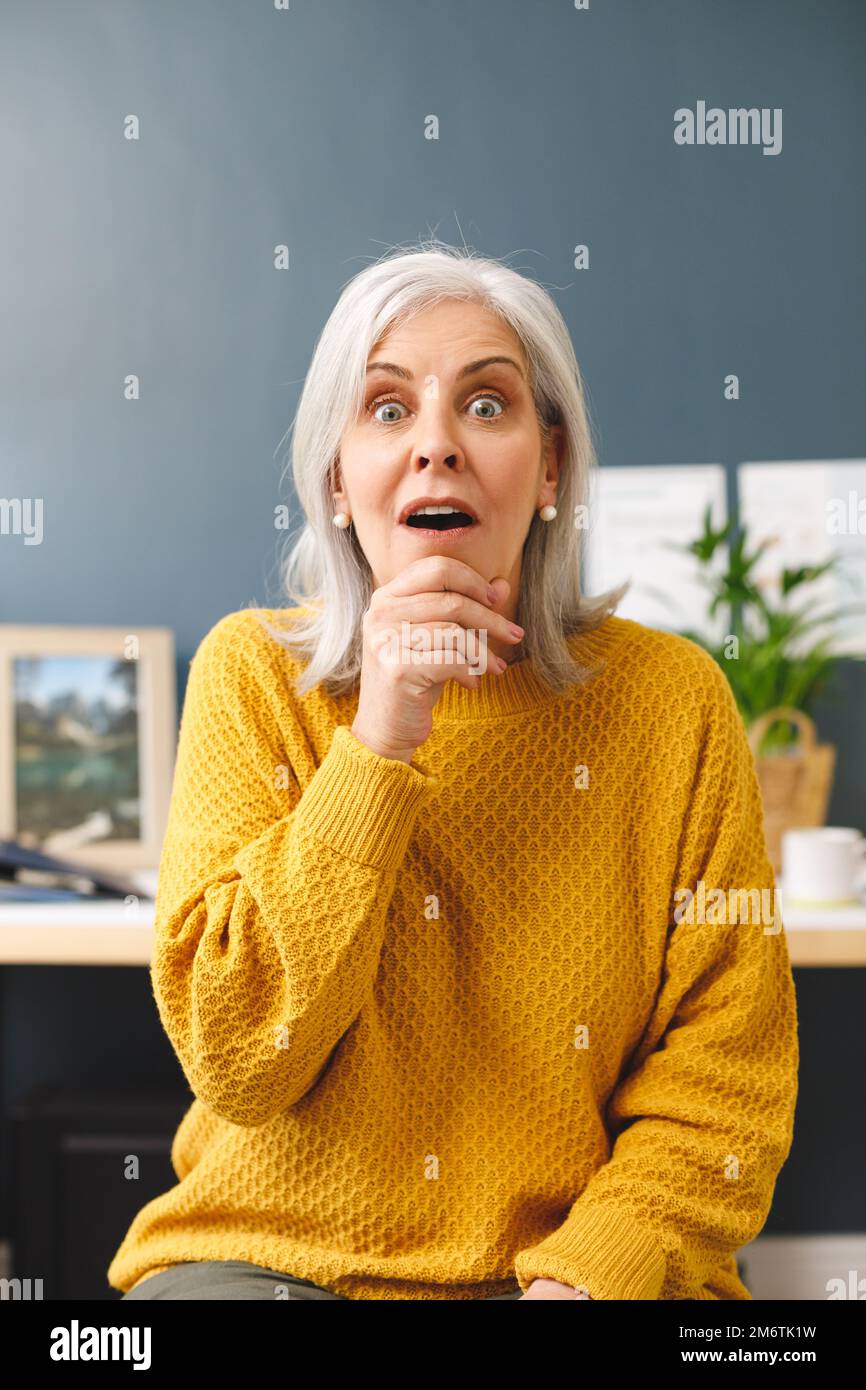 Vertical image of happy caucasian senior woman making video call making ...