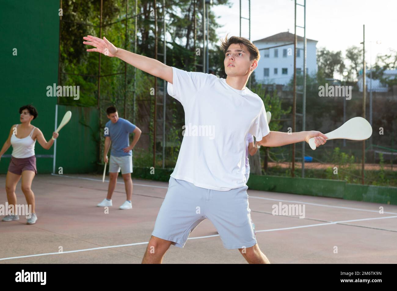 Young man playing Basque pelota on outdoor pelota court Stock Photo - Alamy
