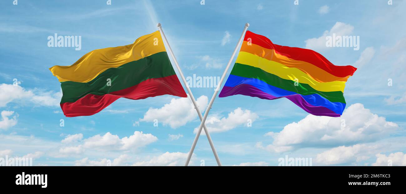 two crossed flags LGBT Pride and Lithuania waving in wind at cloudy sky ...