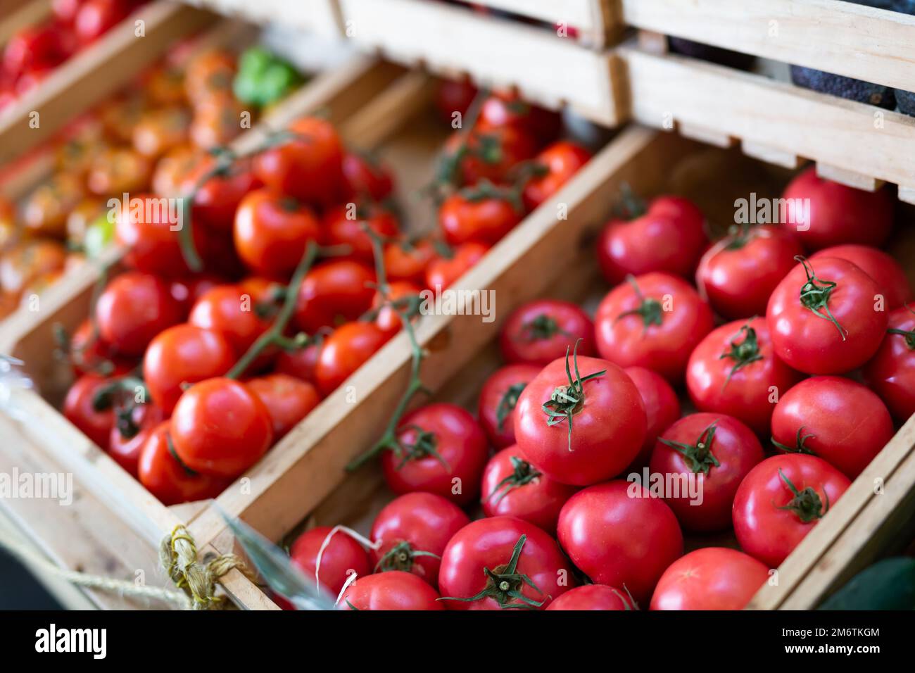 Red tomatoes in wooden boxes Stock Photo - Alamy