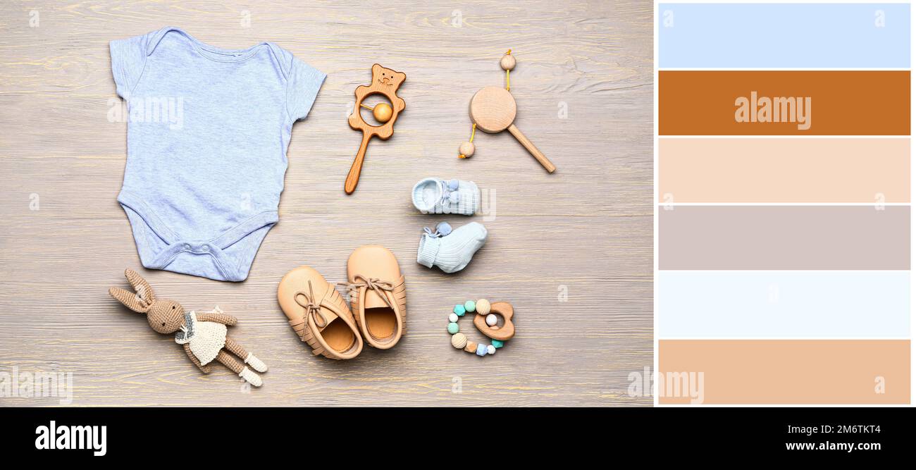 Stylish baby clothes and toys on wooden background. Different color ...