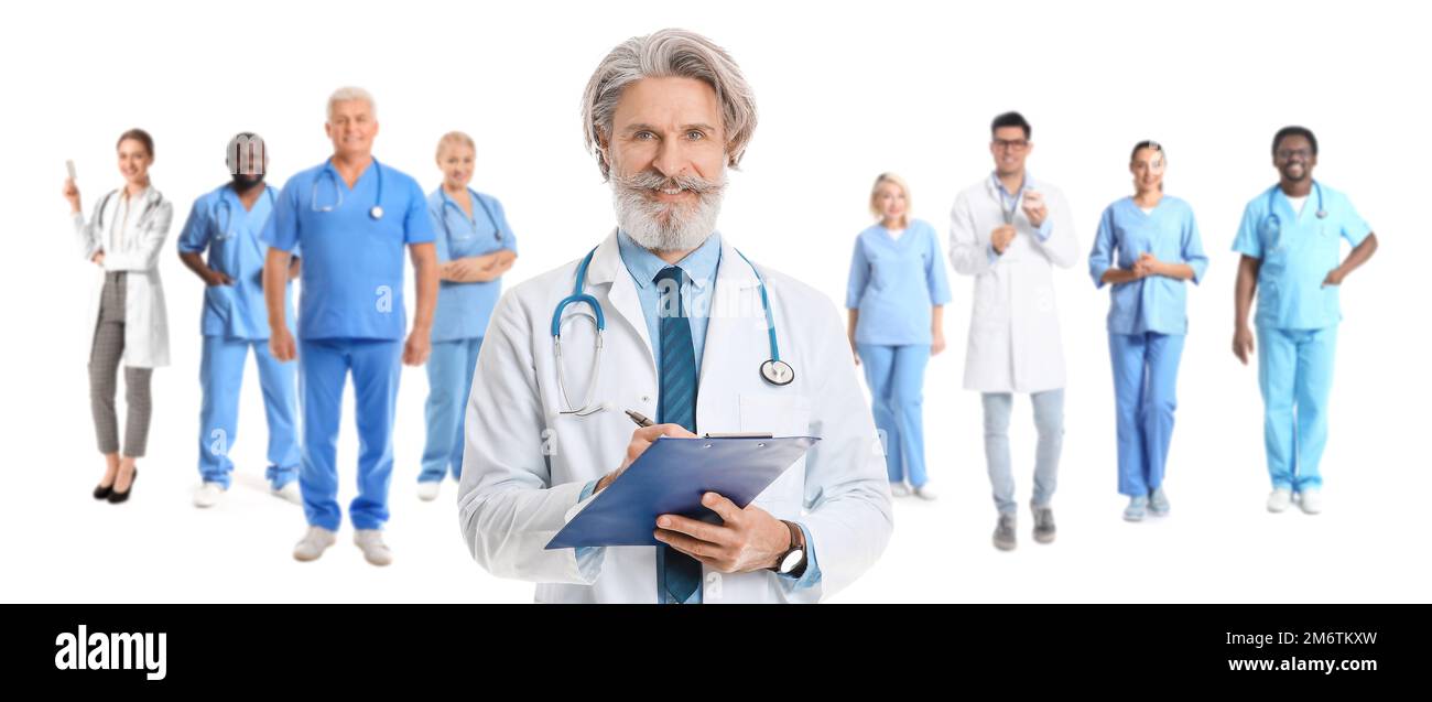 Senior male doctor with group of colleagues on white background Stock ...