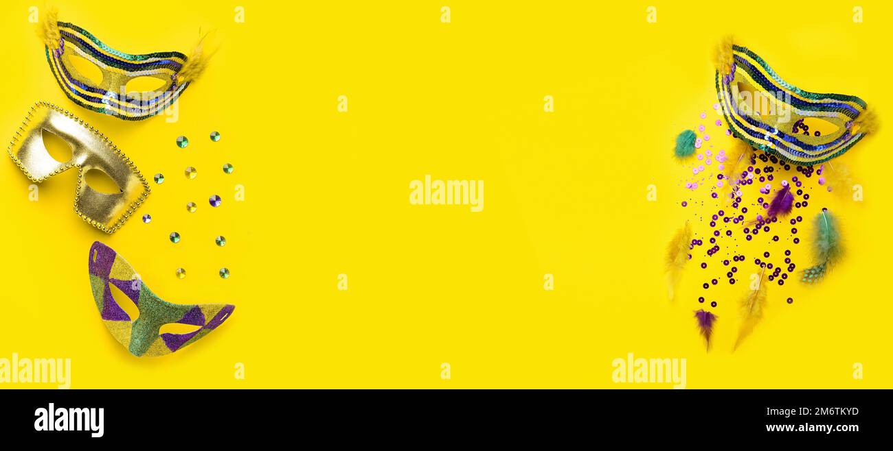 Carnival masks and decor on yellow background with space for text, top ...