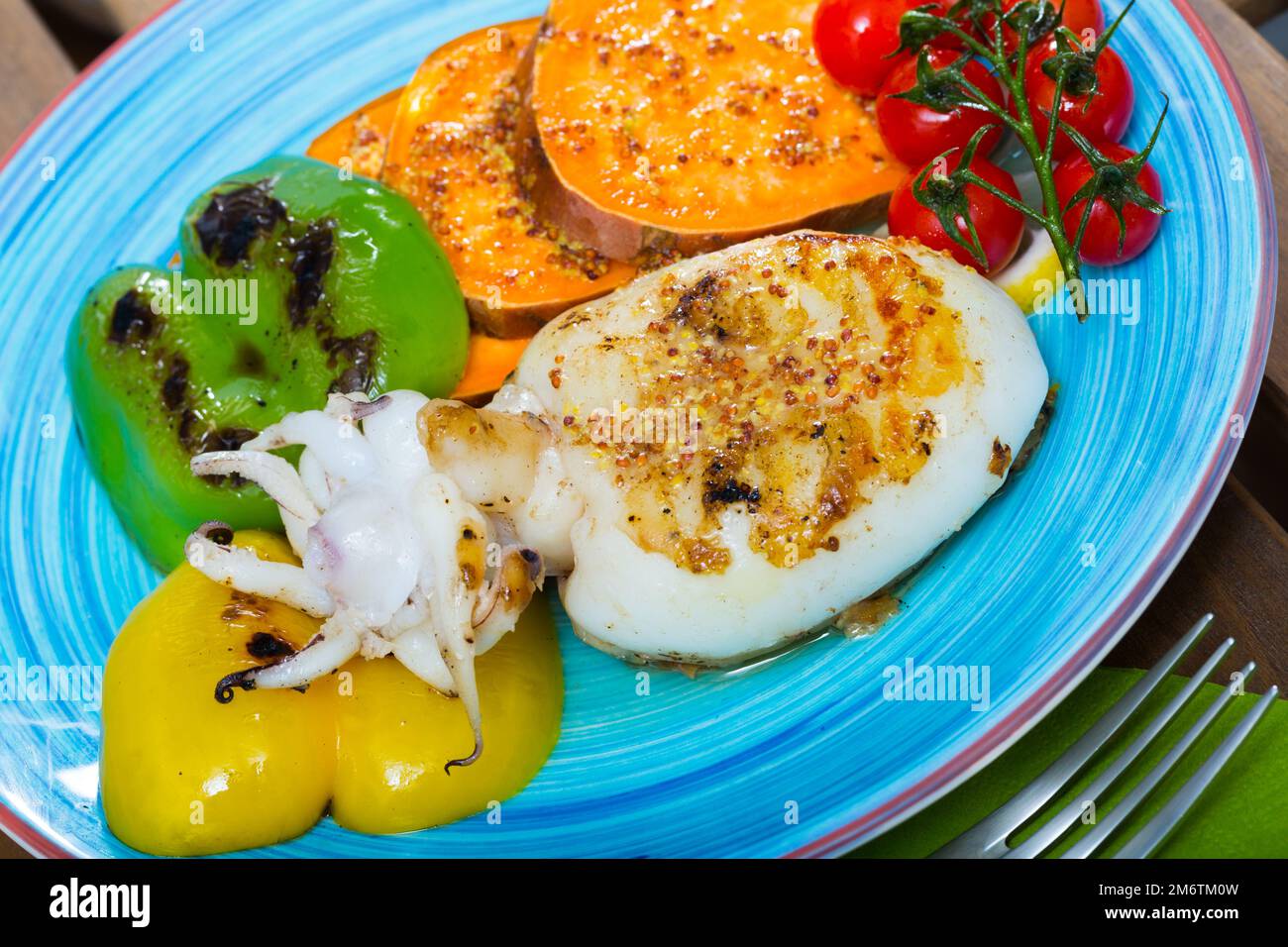 Appetizer cooked at grill sepia with pepper served with boiled batata ...