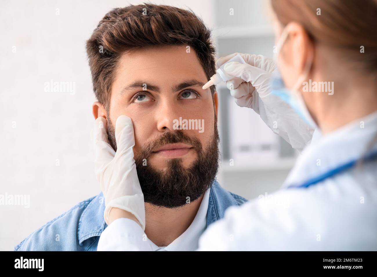 Man putting eye drops in his eyes hi-res stock photography and images ...