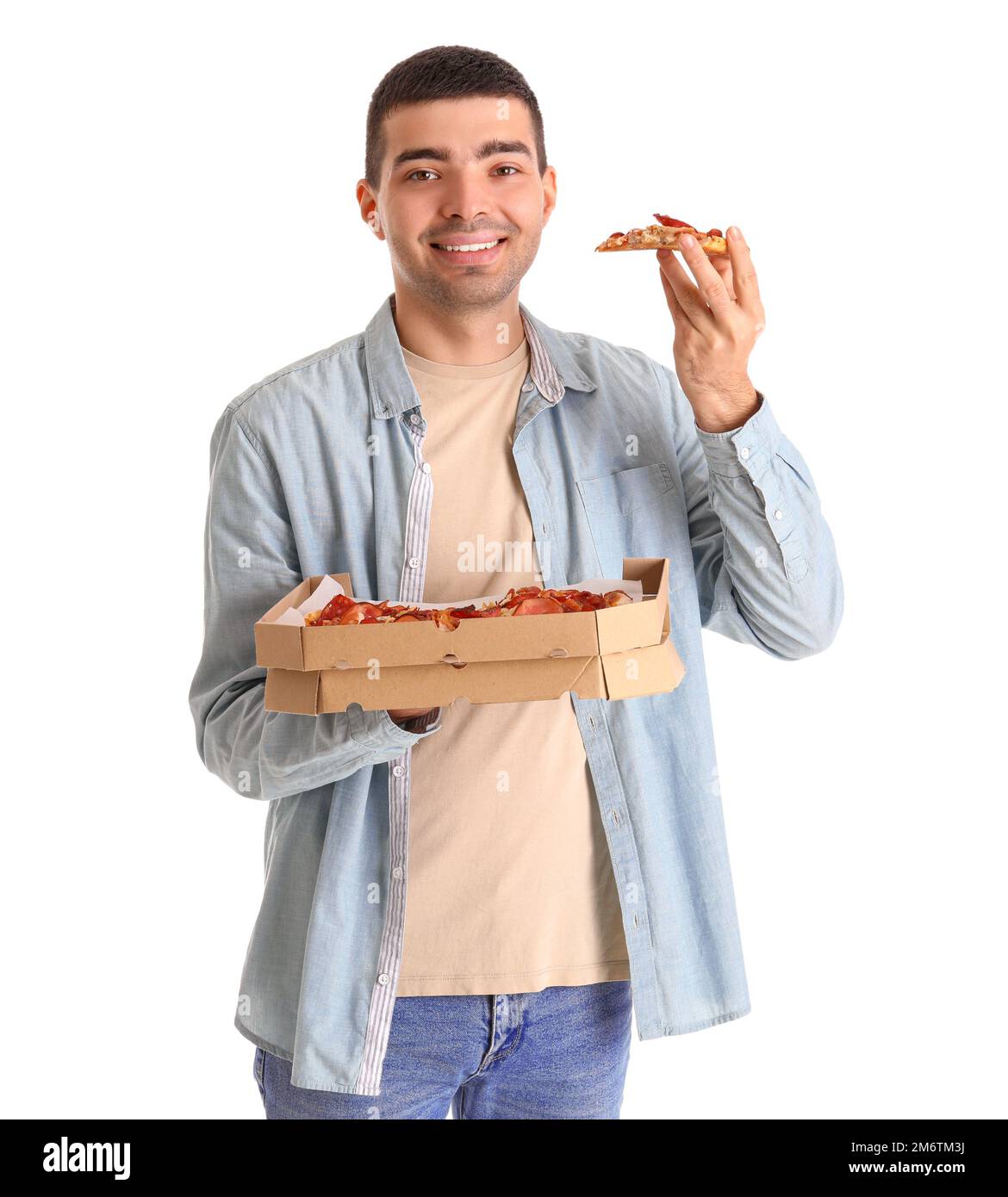 Handsome young man eating fresh pizza on white background Stock Photo ...