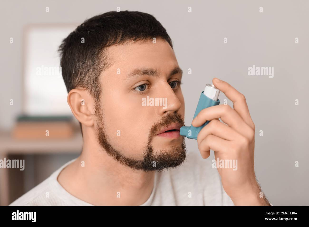 Man using inhaler at home Stock Photo - Alamy