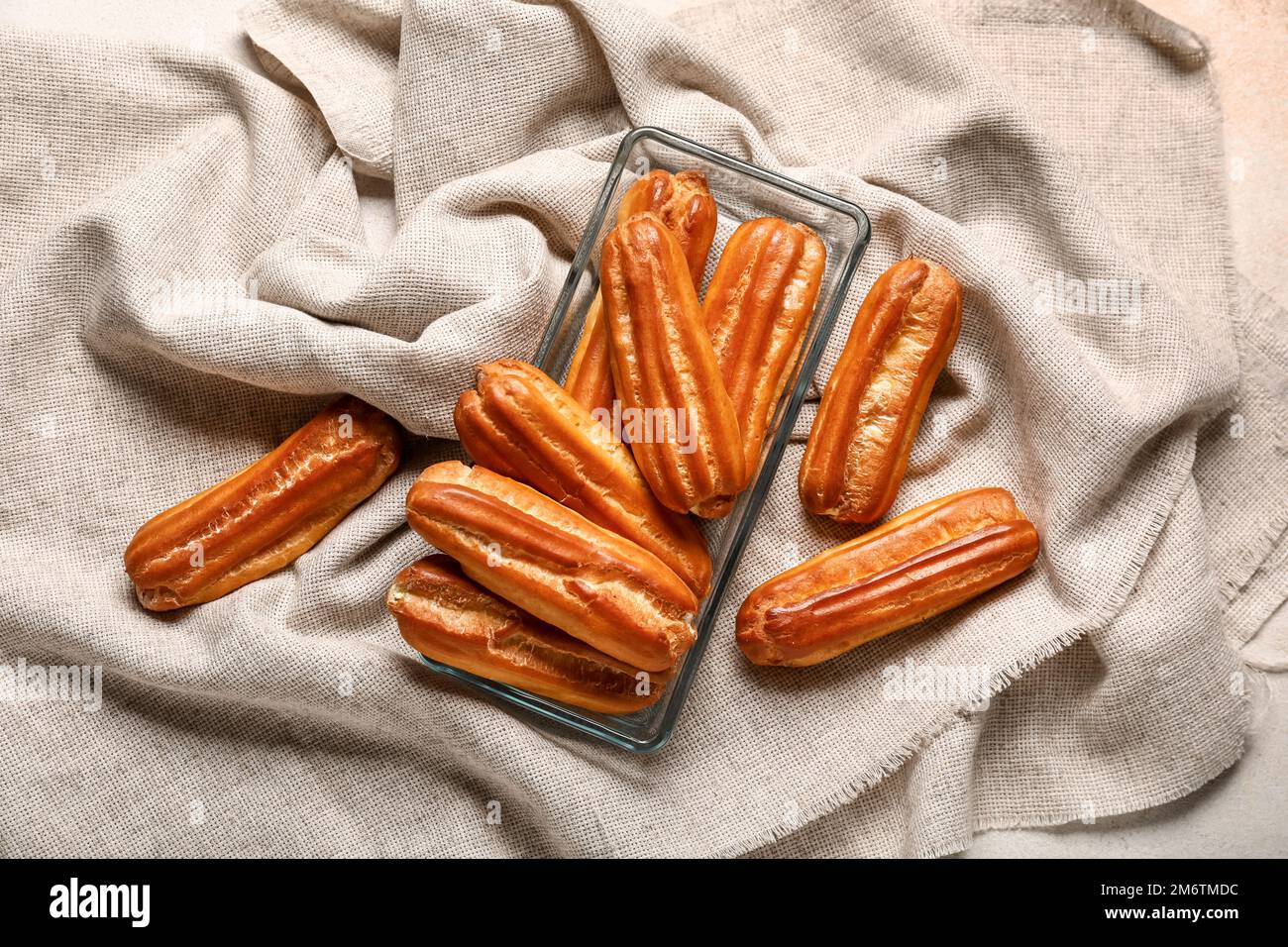 Glass bowl with sweet eclairs on fabric background Stock Photo - Alamy