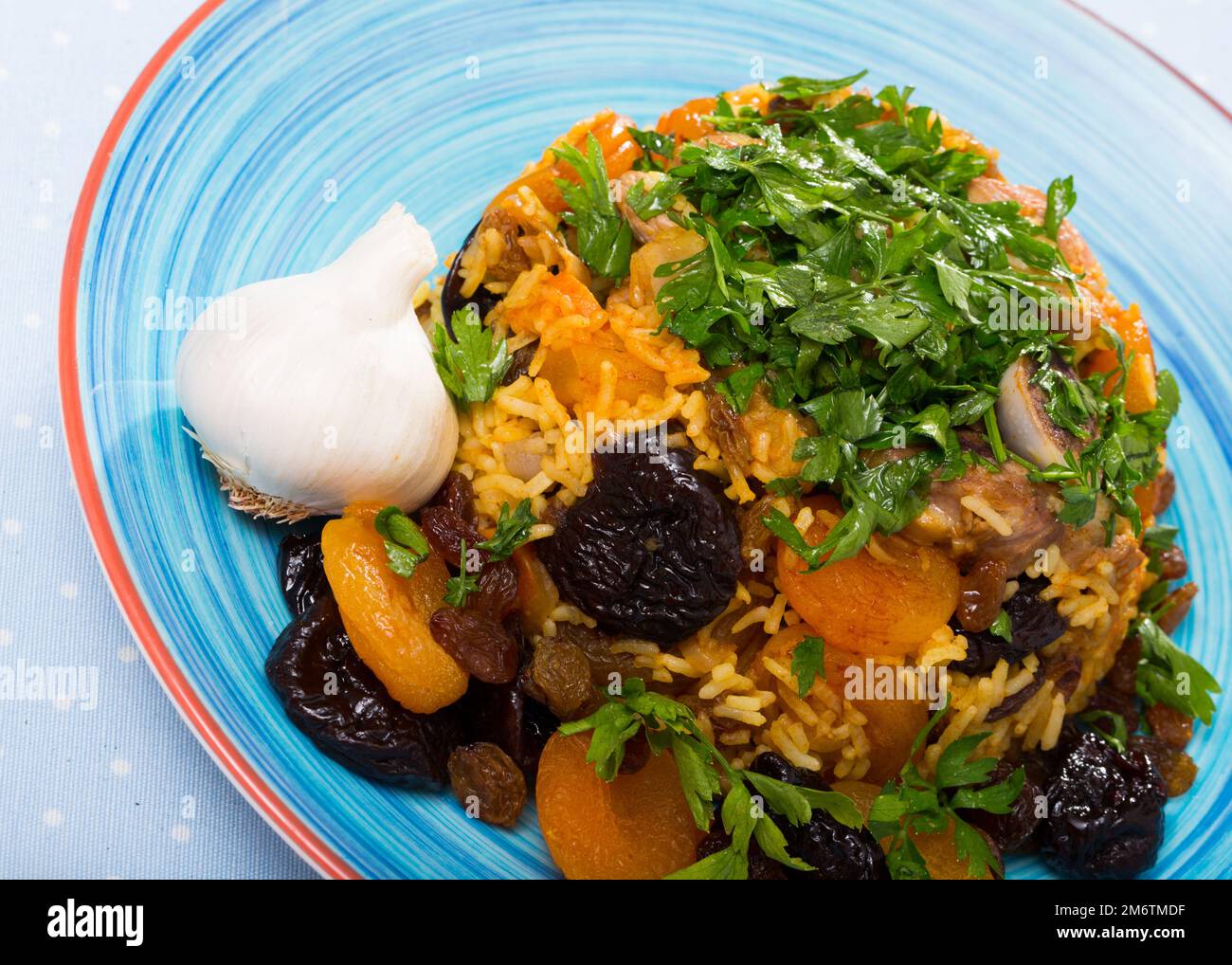 Pilaw with mutton, dried fruits and garlic Stock Photo - Alamy