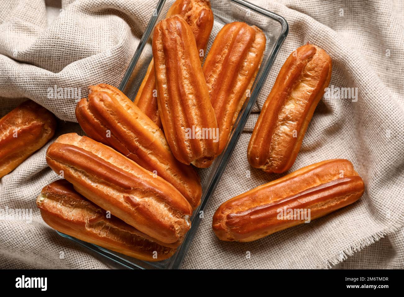 Glass bowl with sweet eclairs on fabric background Stock Photo - Alamy