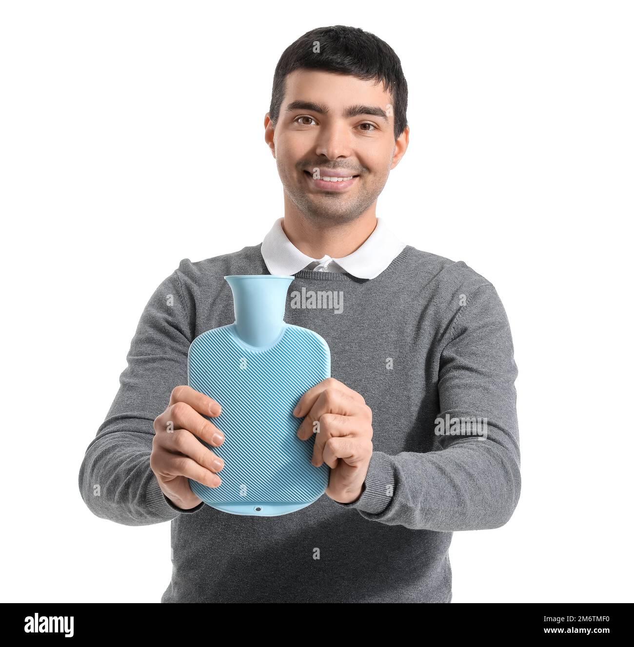 Young man with hot water bottle on white background Stock Photo - Alamy