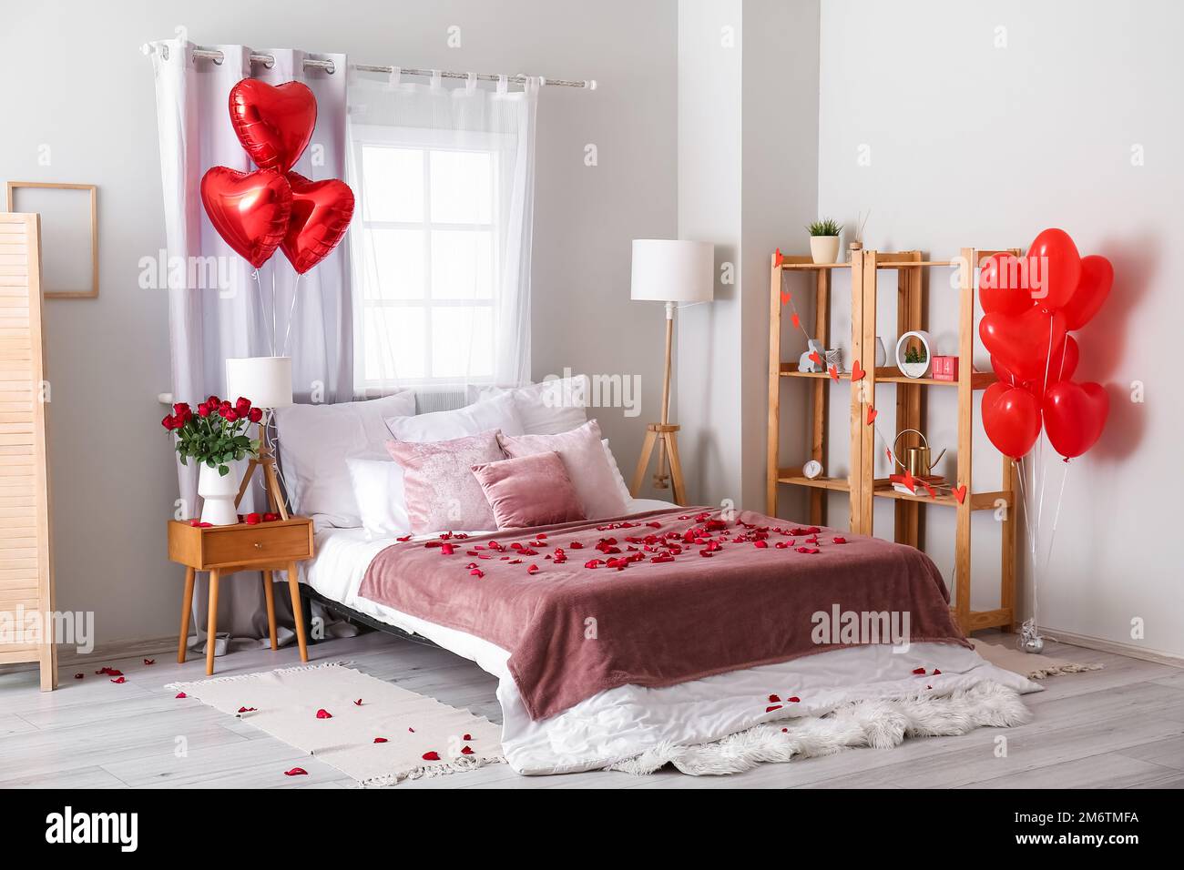 Interior of light bedroom decorated for Valentine's Day with roses ...