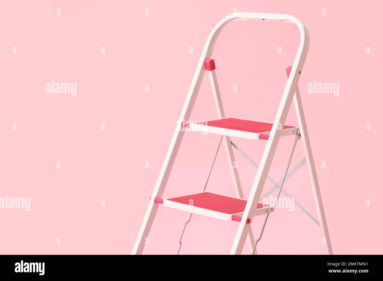 Maintenance ladder on pink background Stock Photo - Alamy