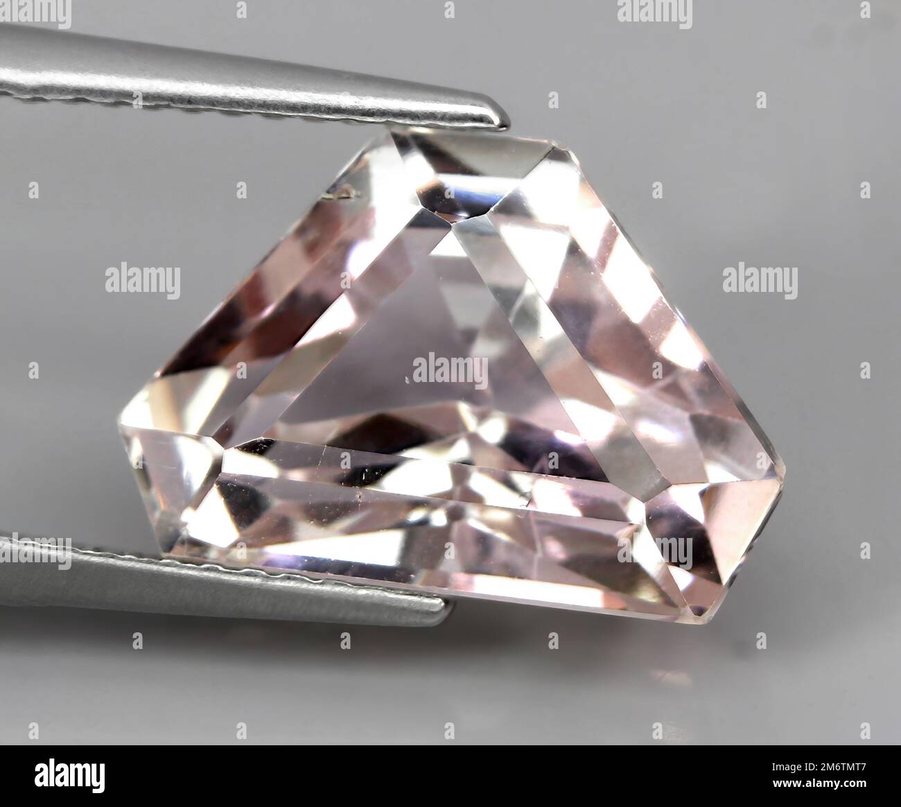Natural beautiful stone kunzite on gray background Stock Photo - Alamy