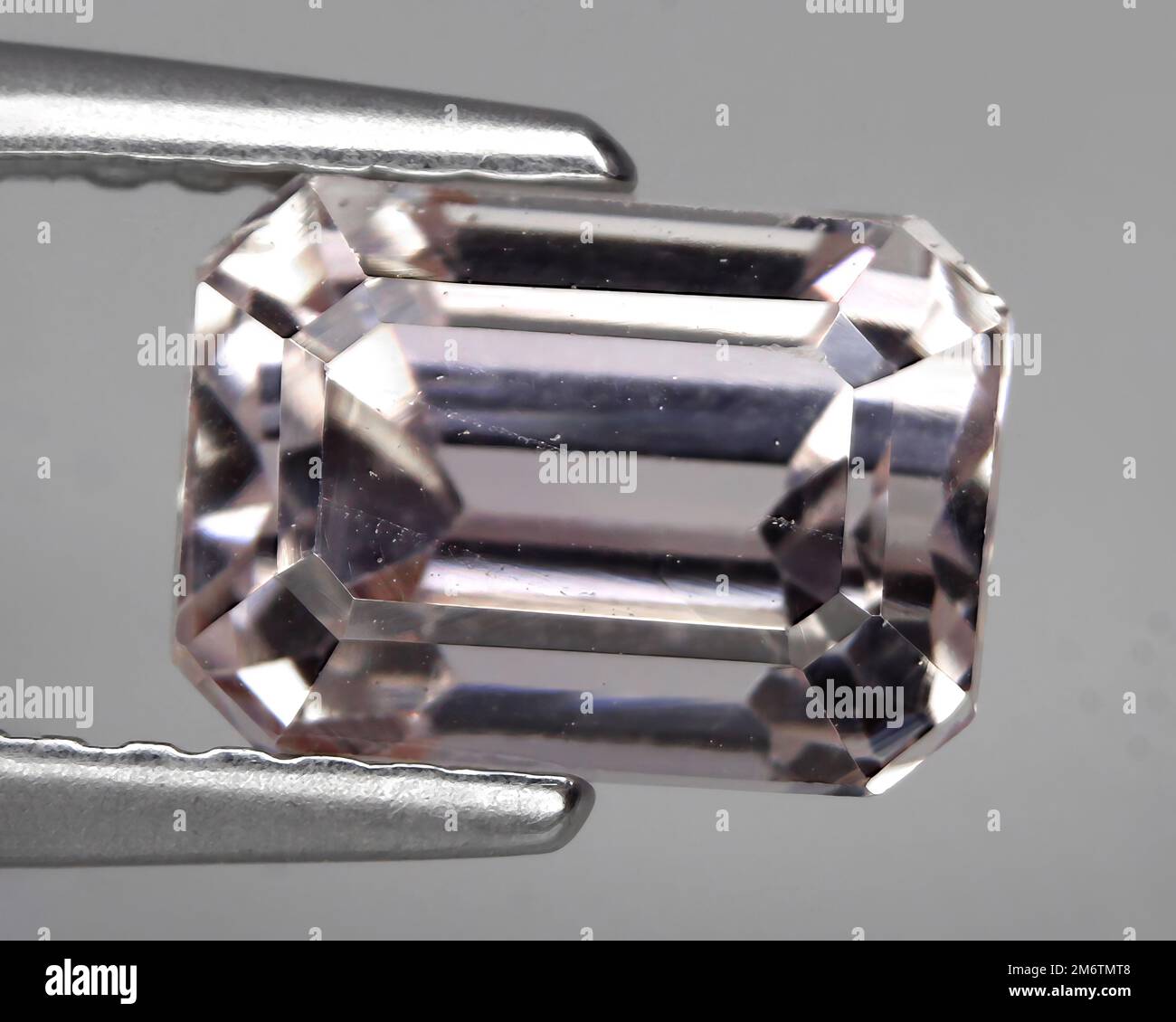 Natural beautiful stone kunzite on gray background Stock Photo - Alamy