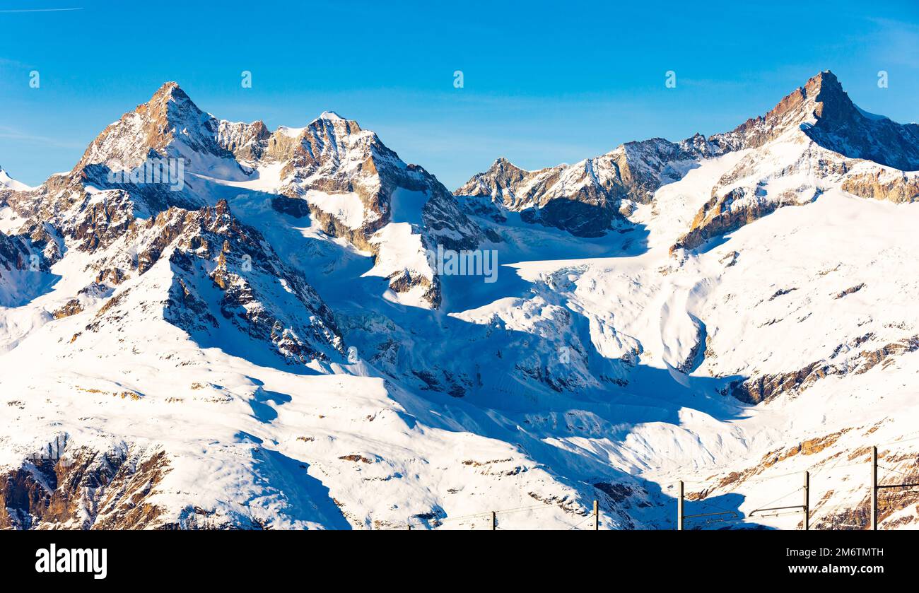 Winter landscape of mountain peaks located near the of Zermatt Stock ...