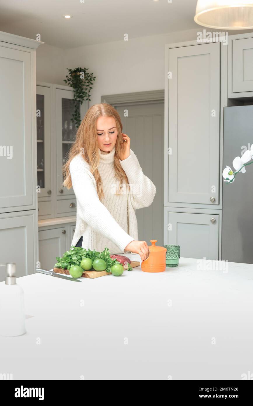 Young woman is preparing in the kitchen. Healthy Food. Salad. Diet ...