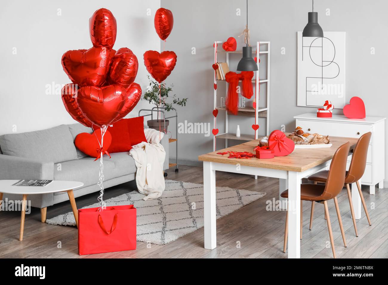 Interior of dining room decorated for Valentine's Day with table, sofa ...