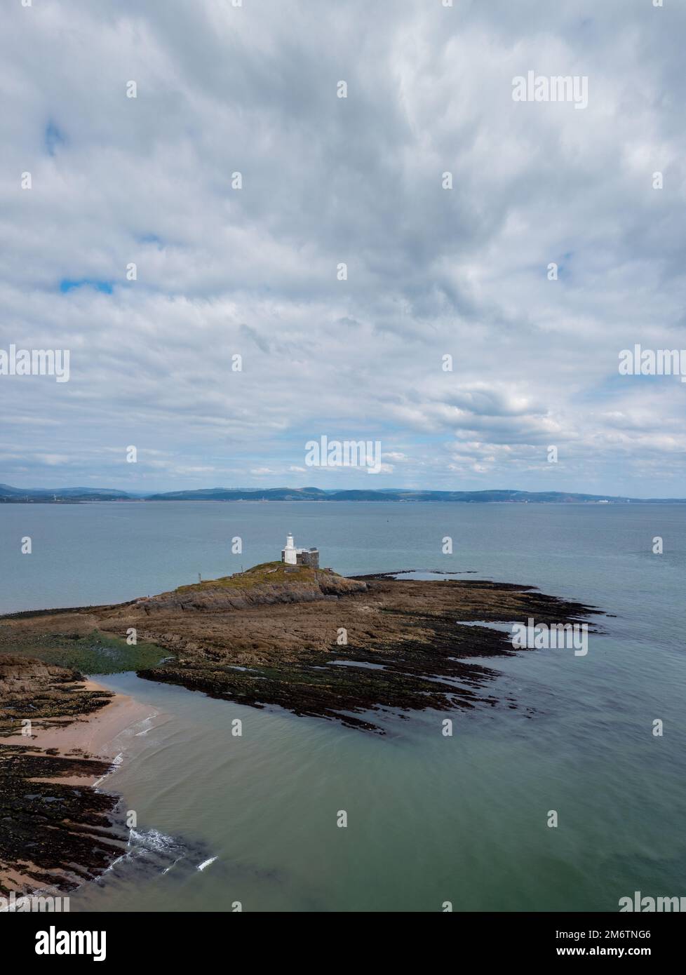 View of the Mumbles Lighthouse in Swansea Bay at low tide Stock Photo ...