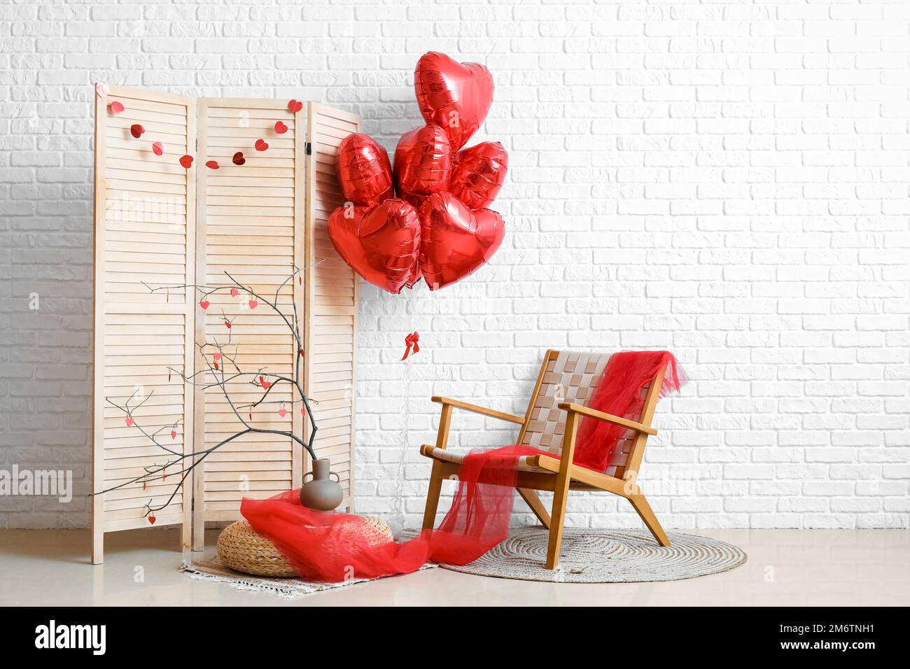Interior of living room with chair, folding screen and red balloons for ...