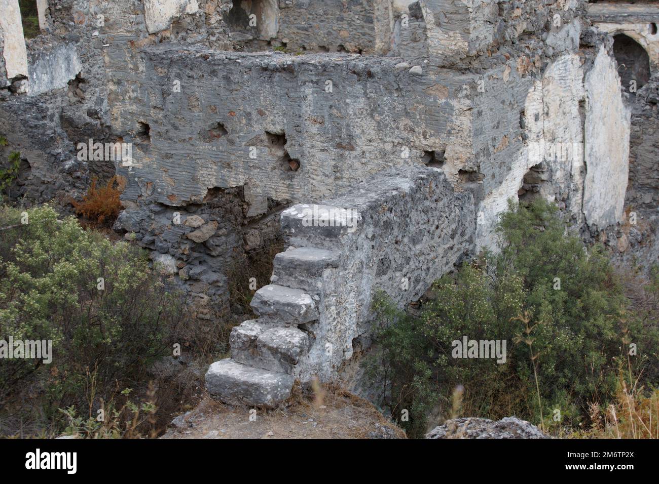 Stone stairs of a ruined house. Greek abandoned stone houses from the ...