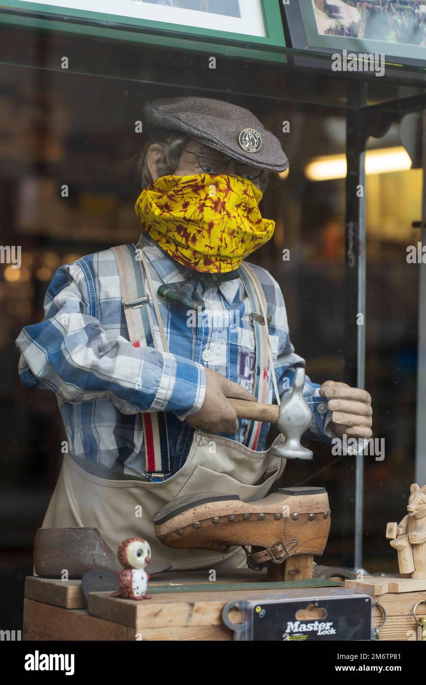 A motorised old advertising dummy in a shoe repair shop window in Kelso ...