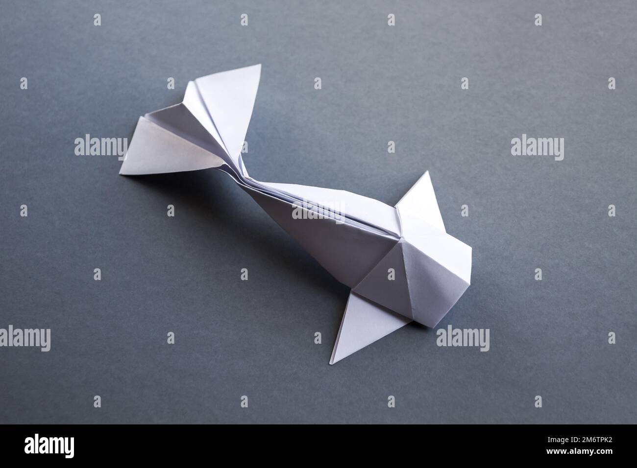 White paper fish origami isolated on a grey background Stock Photo - Alamy