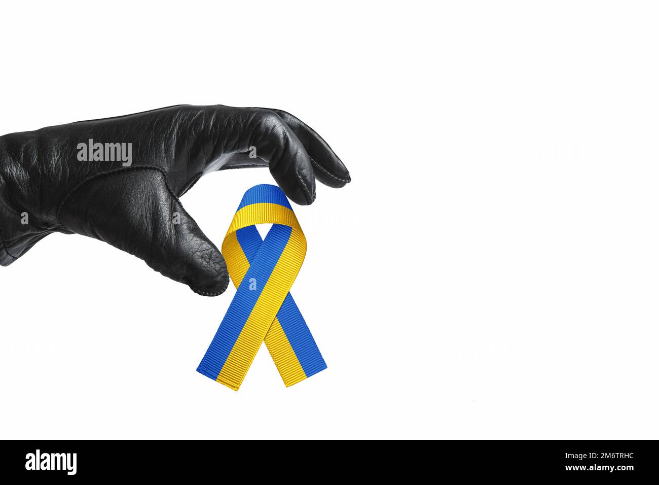 black glove reaches for blue yellow ribbon Stock Photo - Alamy