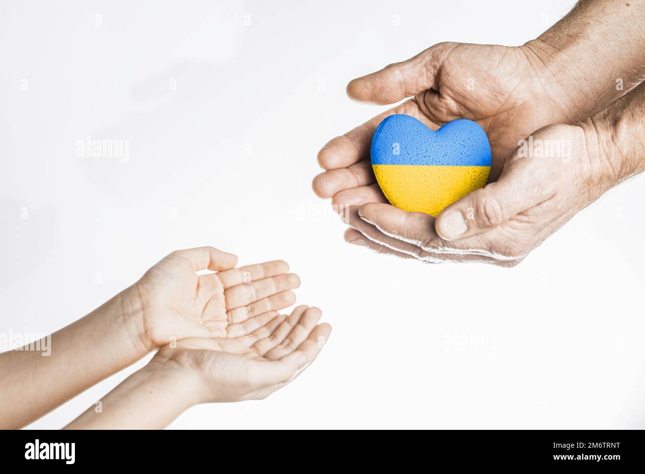 hands give yellow blue heart Stock Photo - Alamy