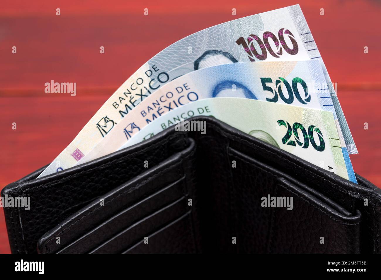 Mexican Peso in the black wallet Stock Photo - Alamy