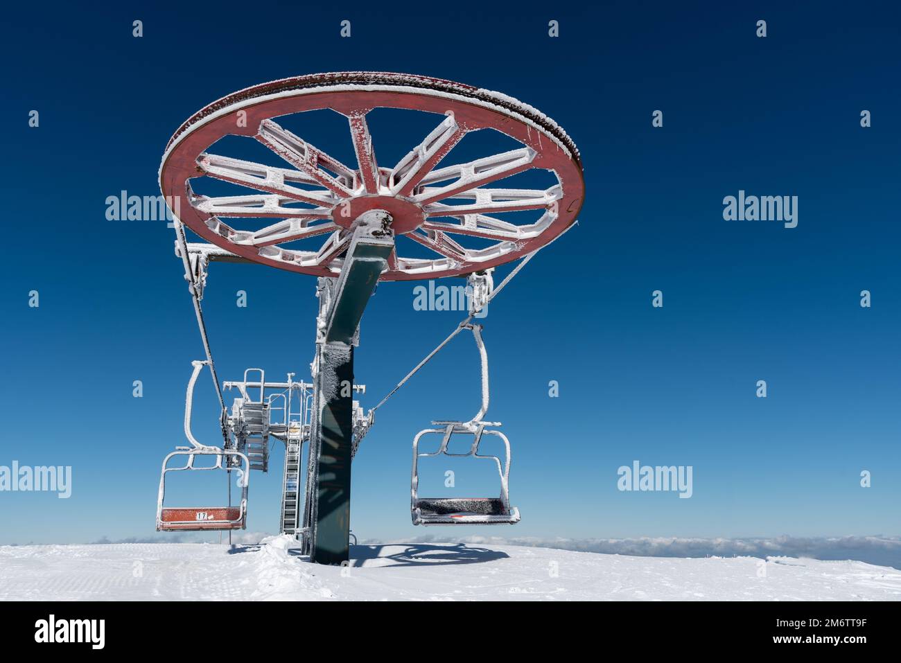 Frozen Ski lift on a snowy mountain against blue sky Stock Photo - Alamy