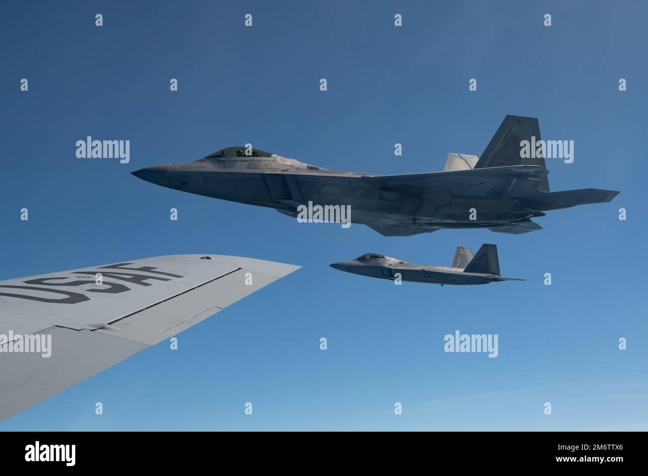 U.S. Air Force F-22 Raptors with the 192nd Fighter Wing, fly alongside ...
