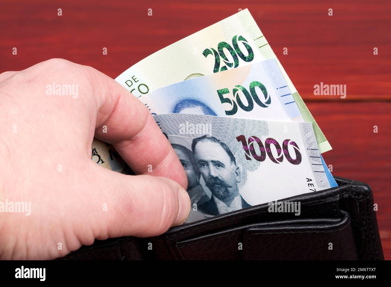Mexican Peso in the black wallet Stock Photo - Alamy