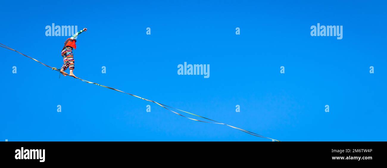 Slackline athlete during his performance. Concentration, balance and ...