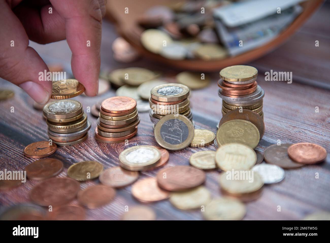 Human hand placing coin money stack after breaking box. Concept of ...