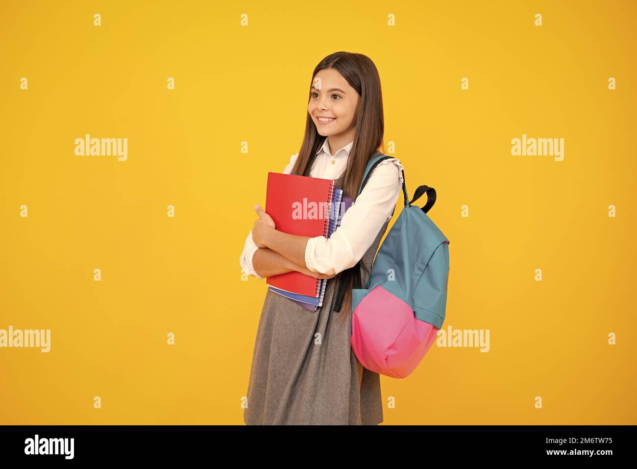 Schoolchild, teenage student girl hold book on yellow isolated studio ...