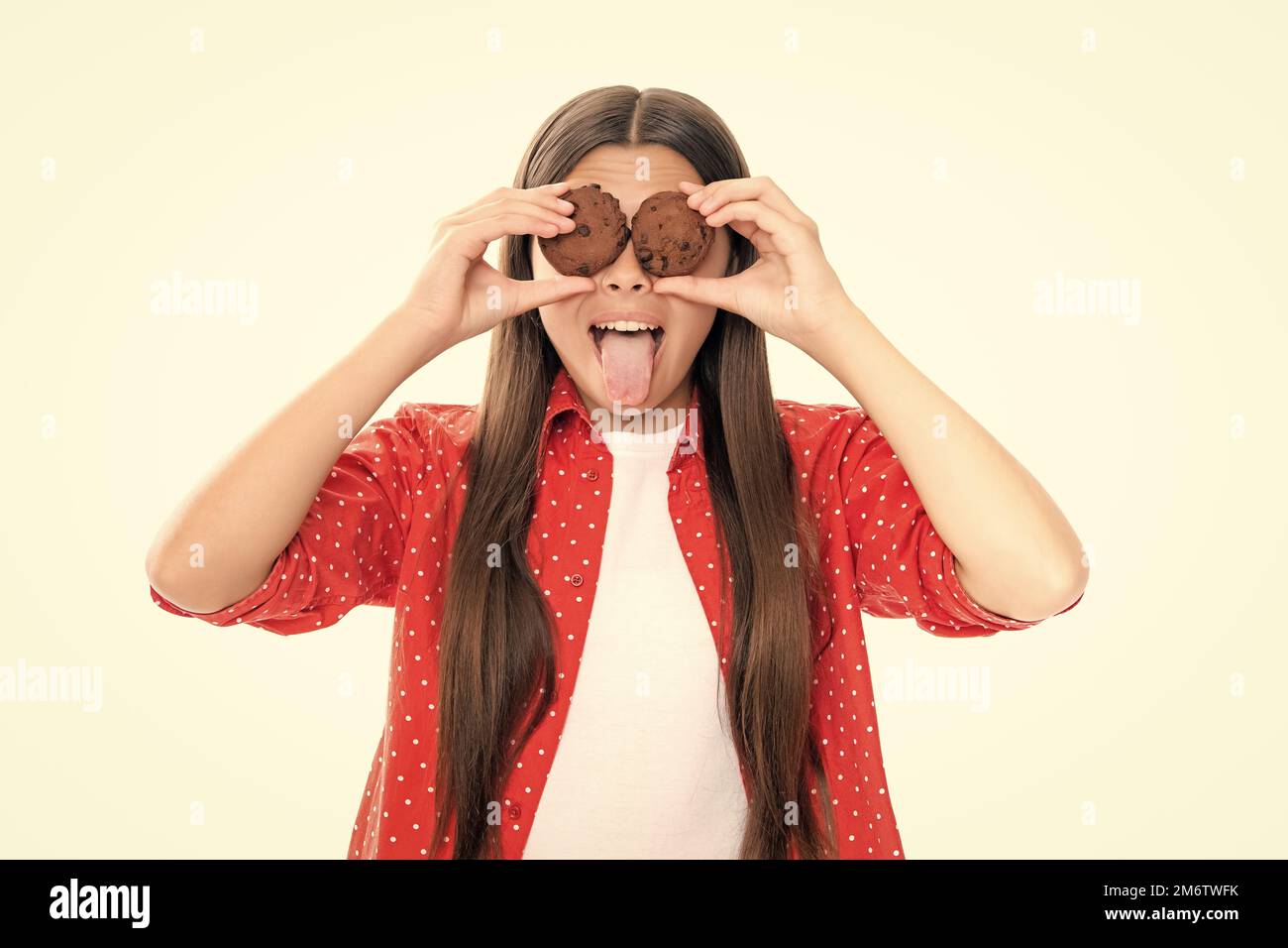 Funny face. Teen girl eating cookies, happy childhood, food, sweets and ...